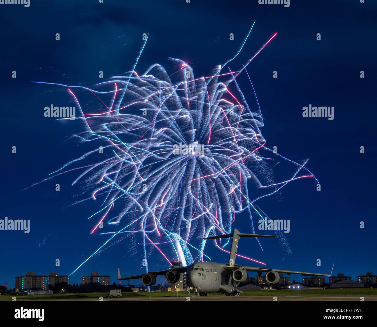 Fireworks explode behind a U.S. Air Force C-17 Globemaster III aircraft assigned to the 15th ...