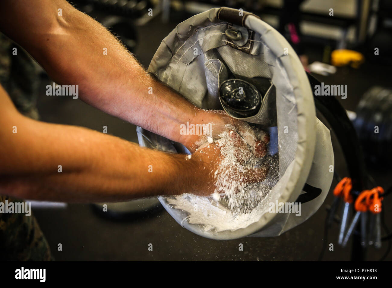 A U.S. Marine applies chalk on his hands during the 2018 High Intensity ...