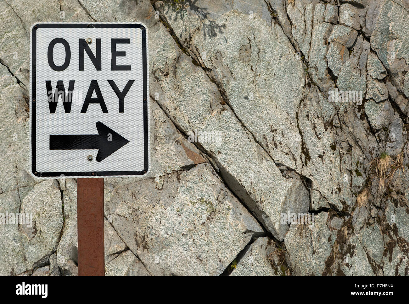One Way highway road sign against grunge texture rock wall Stock Photo ...