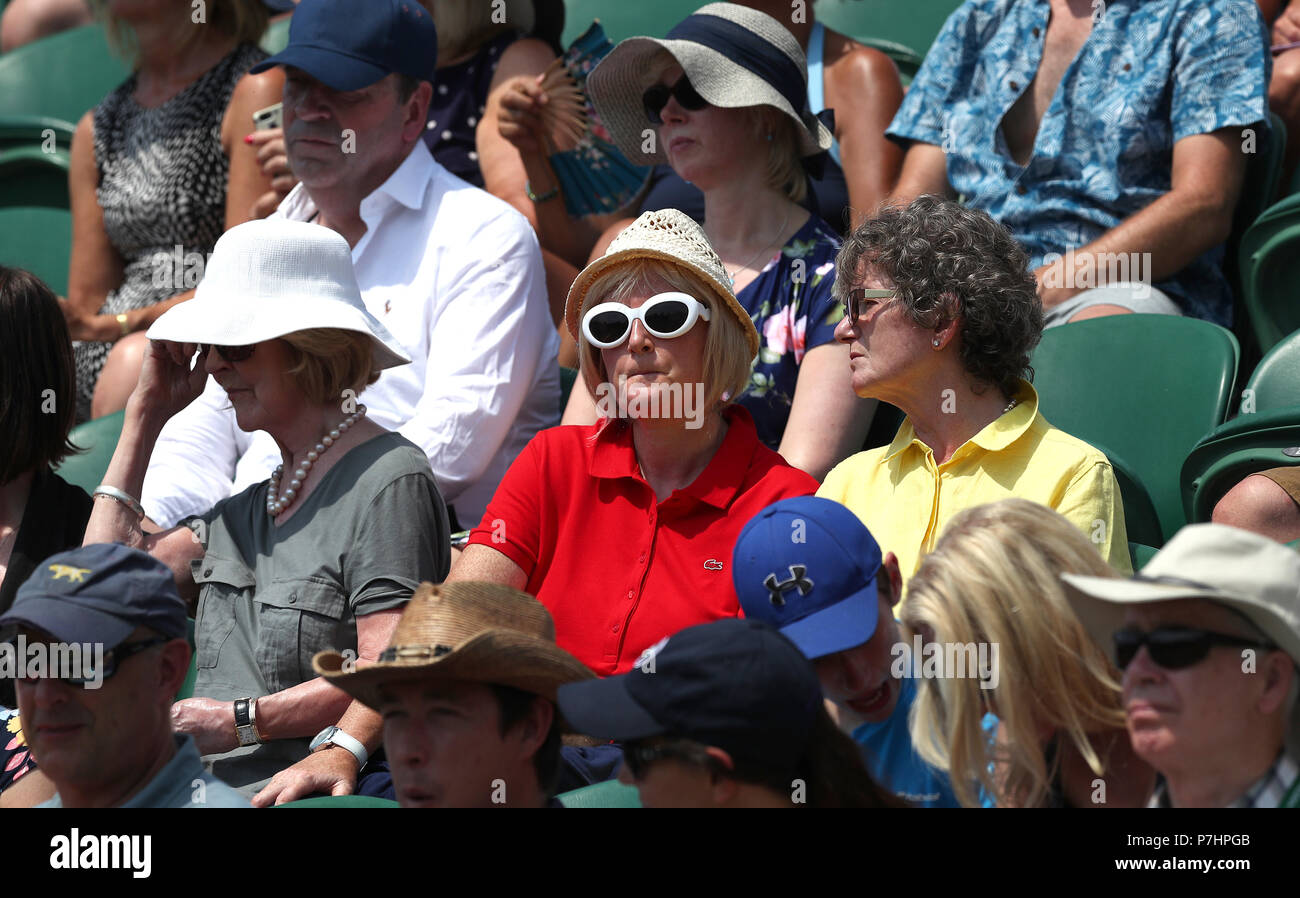 Spectators shield themselves from the sun on court 2 on day five of the ...