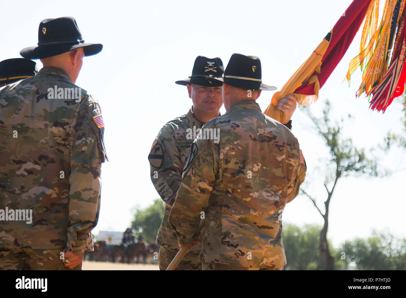 Col. John Woodward passes the brigade guidon to Maj. Gen. Paul Calvert ...