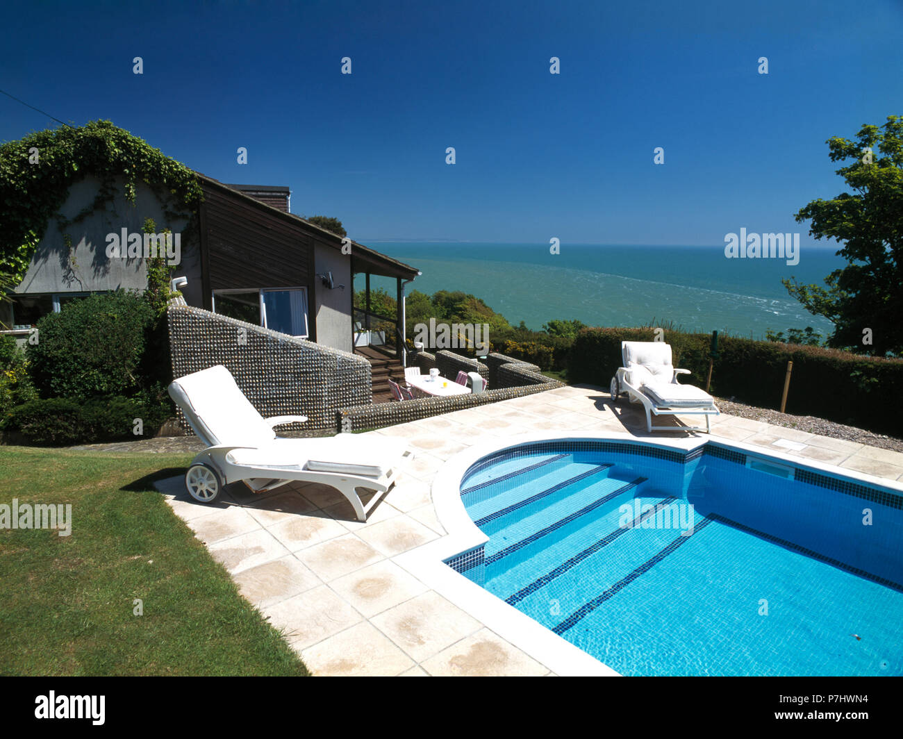 Modern coastal house with turquoise swimming pool and view of the sea ...