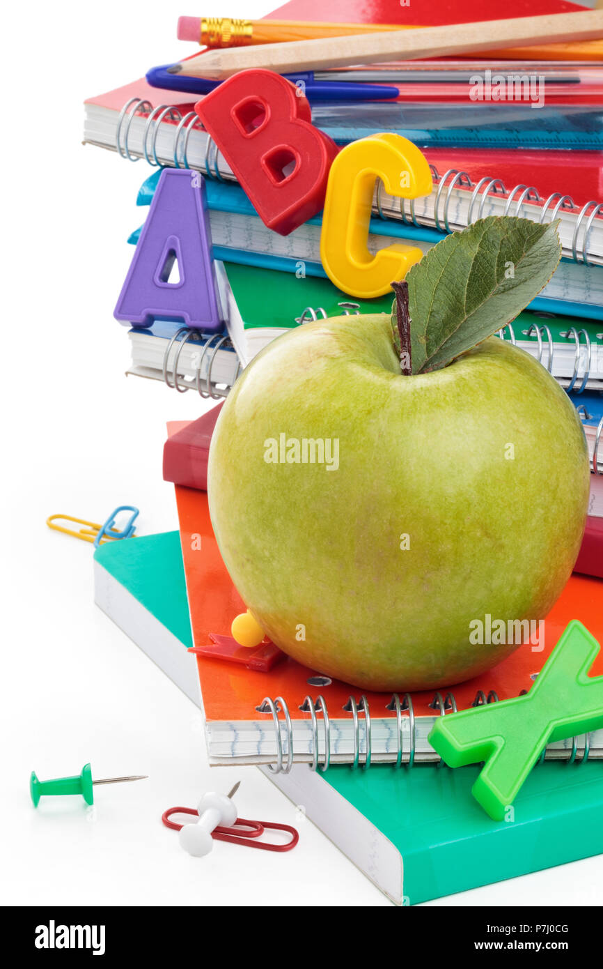 School supplies and green apple isolated on white background Stock ...