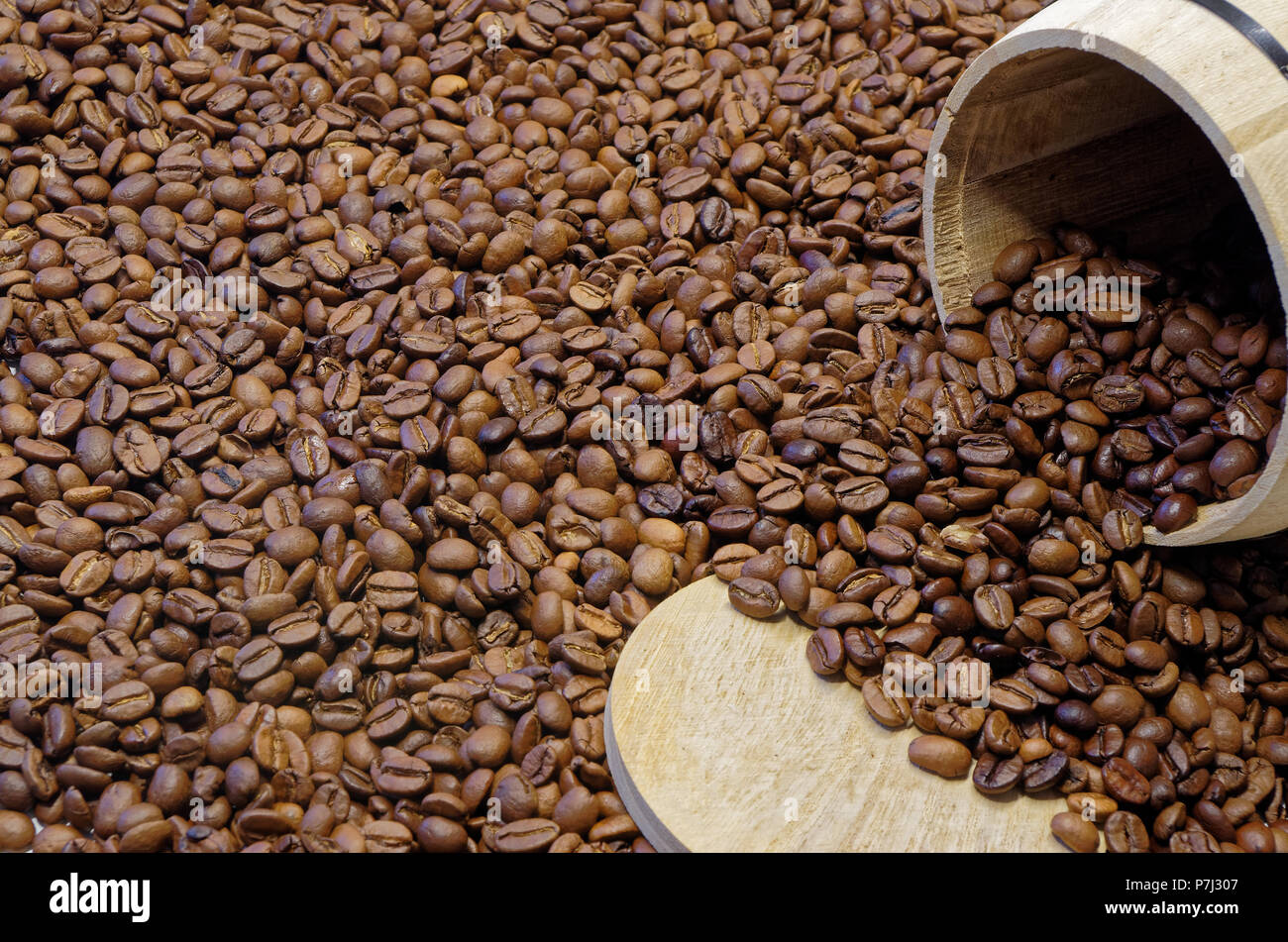 Wooden round box with lid laying on the side in roasted coffee beans ...