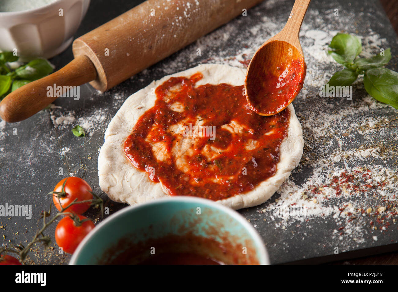 Homemade italian pizza preparation Stock Photo - Alamy
