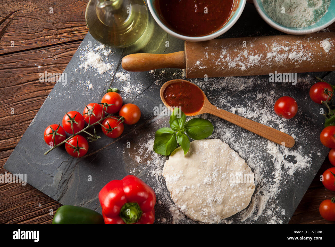 Homemade italian pizza preparation Stock Photo - Alamy