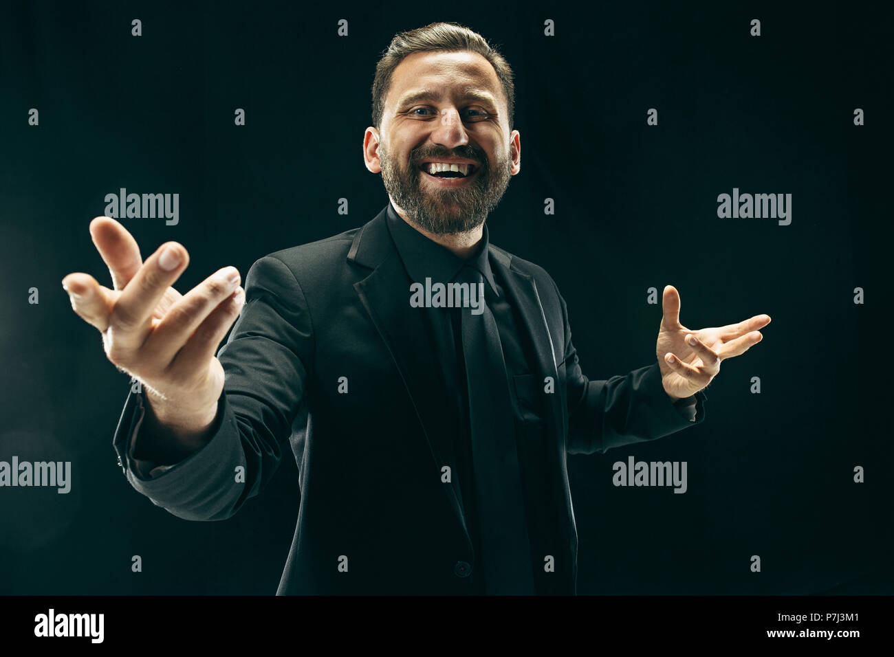 The barded man in a suit at black studio Stock Photo - Alamy