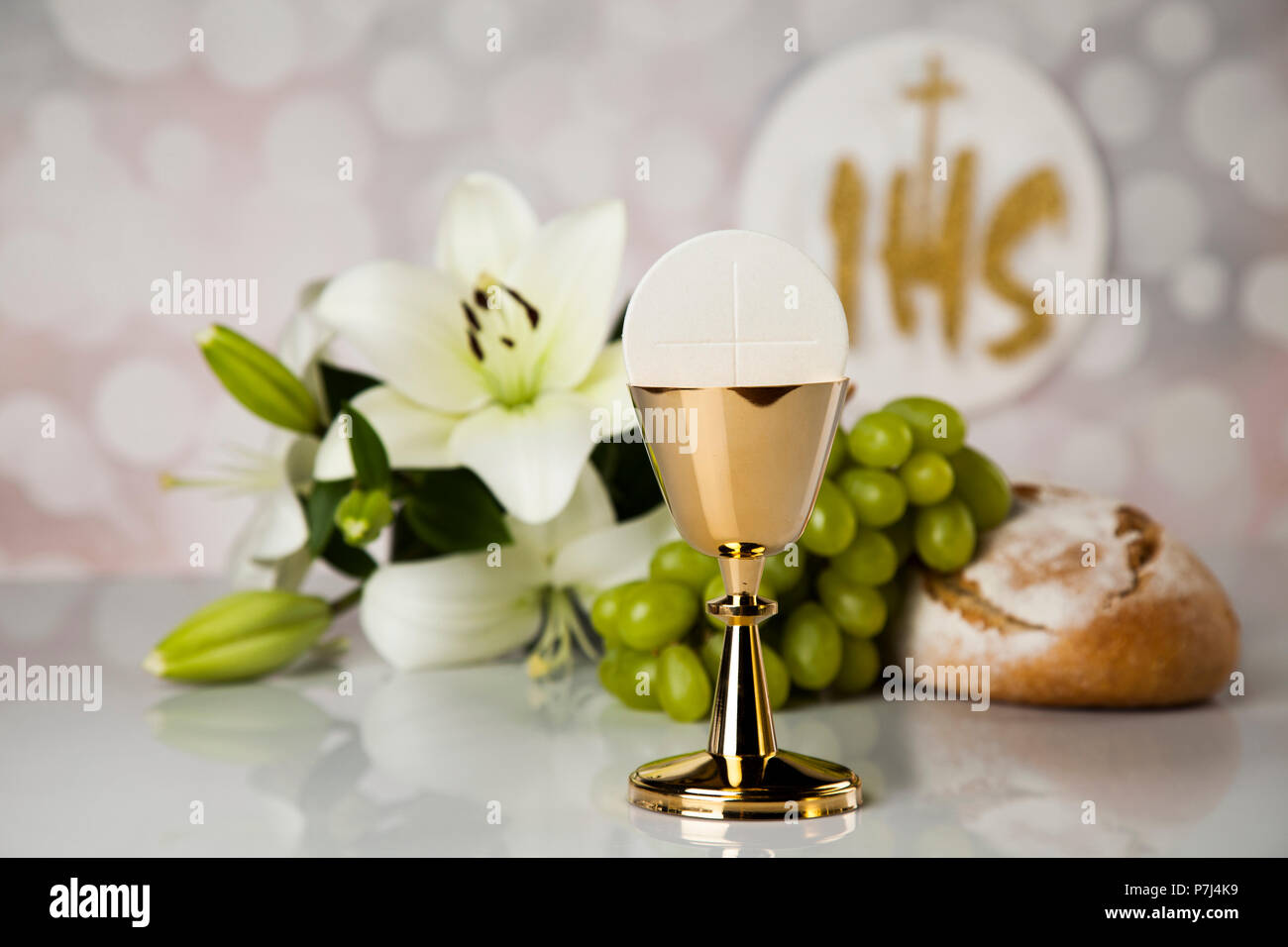Holy communion a golden chalice with grapes and bread wafers Stock ...