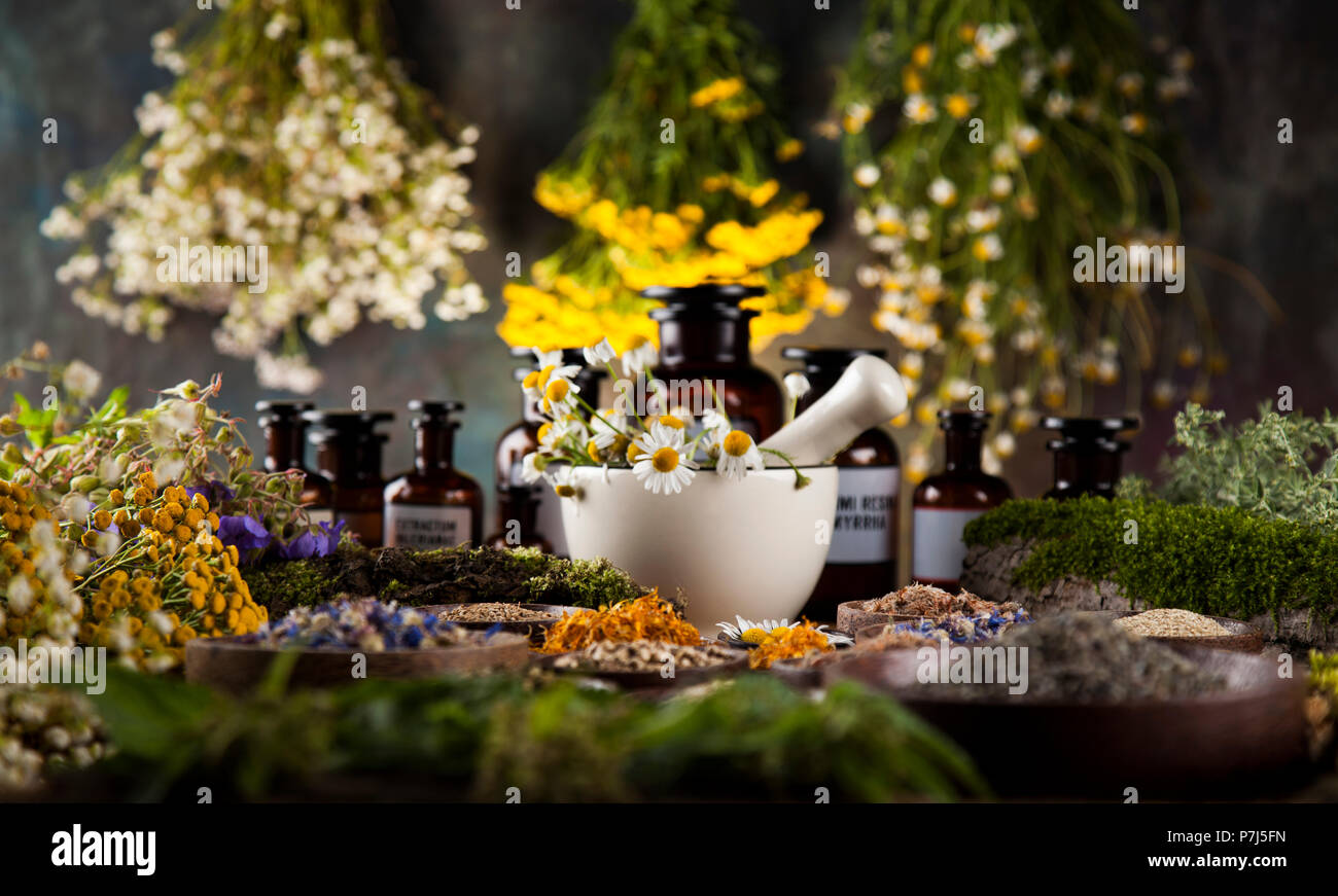 Natural remedy and mortar, healing herbs background Stock Photo - Alamy