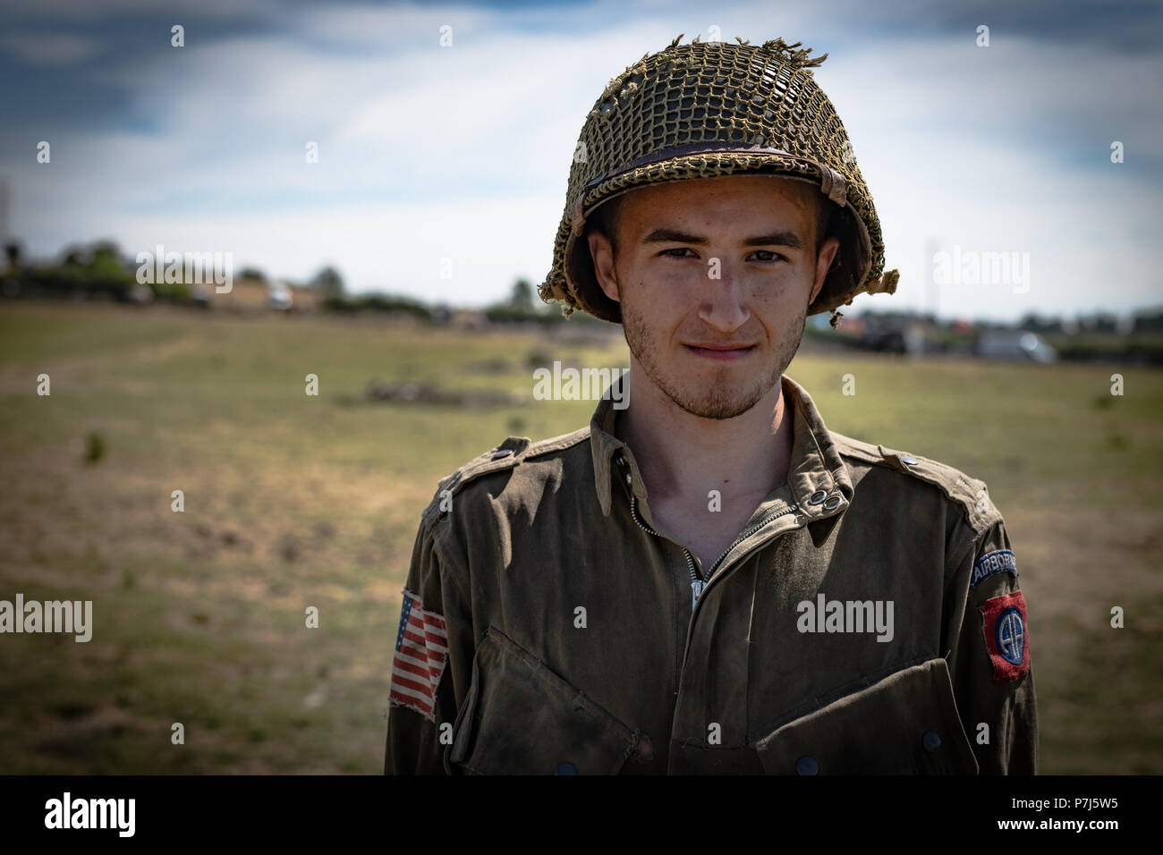 Single american soldier with filed behind him Stock Photo - Alamy