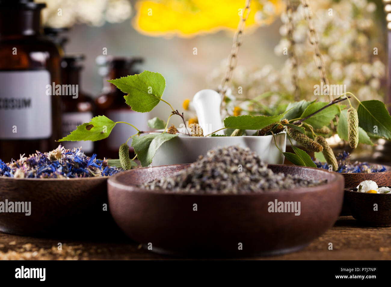 Natural remedy and mortar, healing herbs background Stock Photo - Alamy