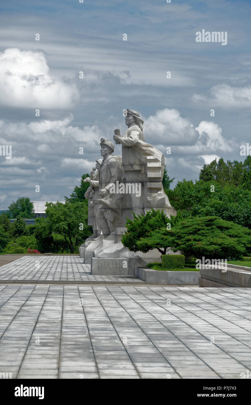 White granite statue of workers in heroic pose by the Juche Tower ...