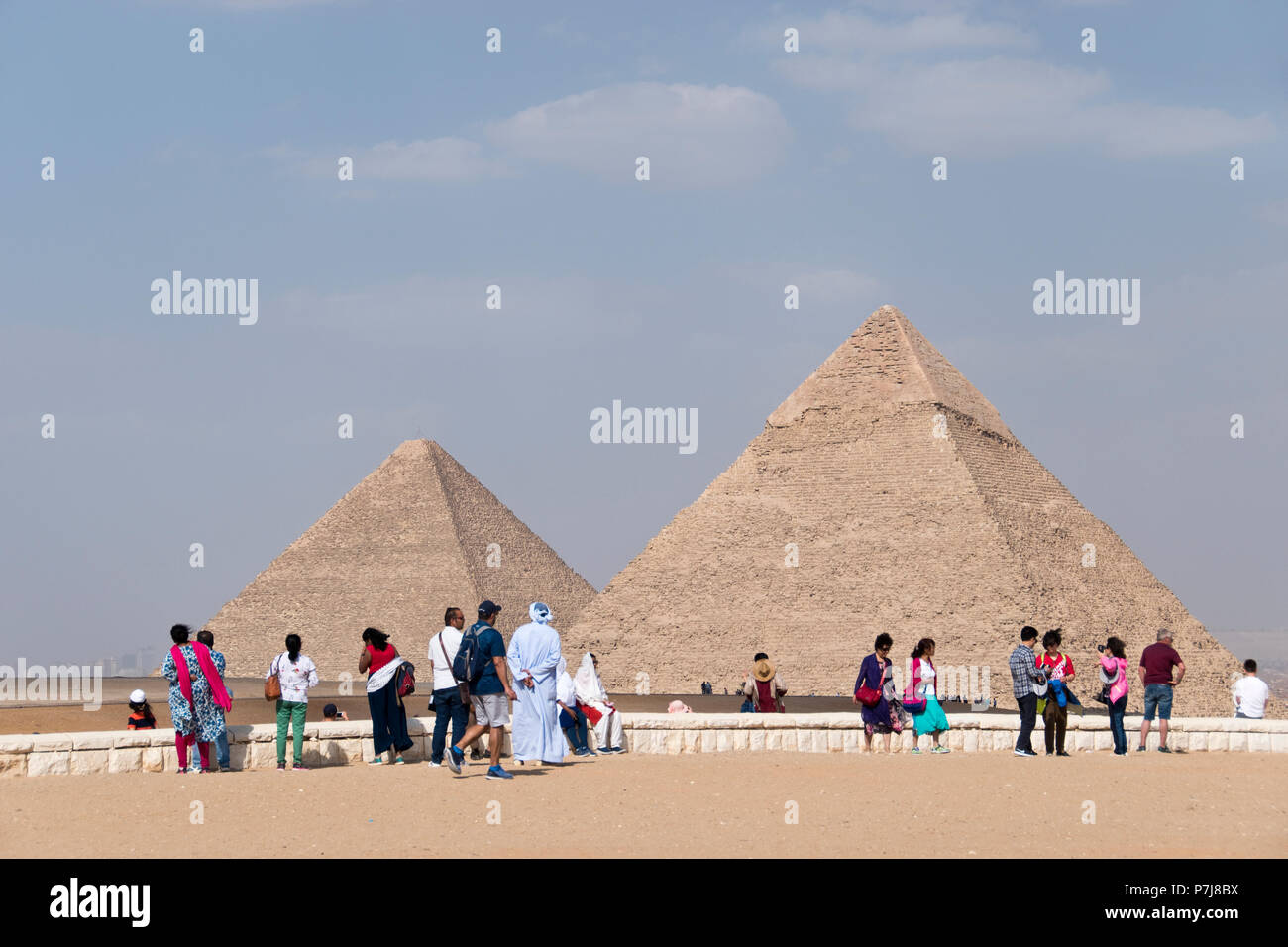International tourists at the Great Pyramid of Giza (left) and the ...