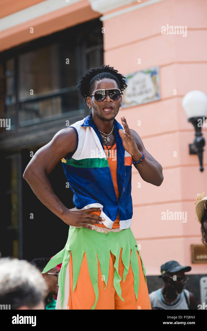 A street performance with stilt dancers and musicians in historic ...