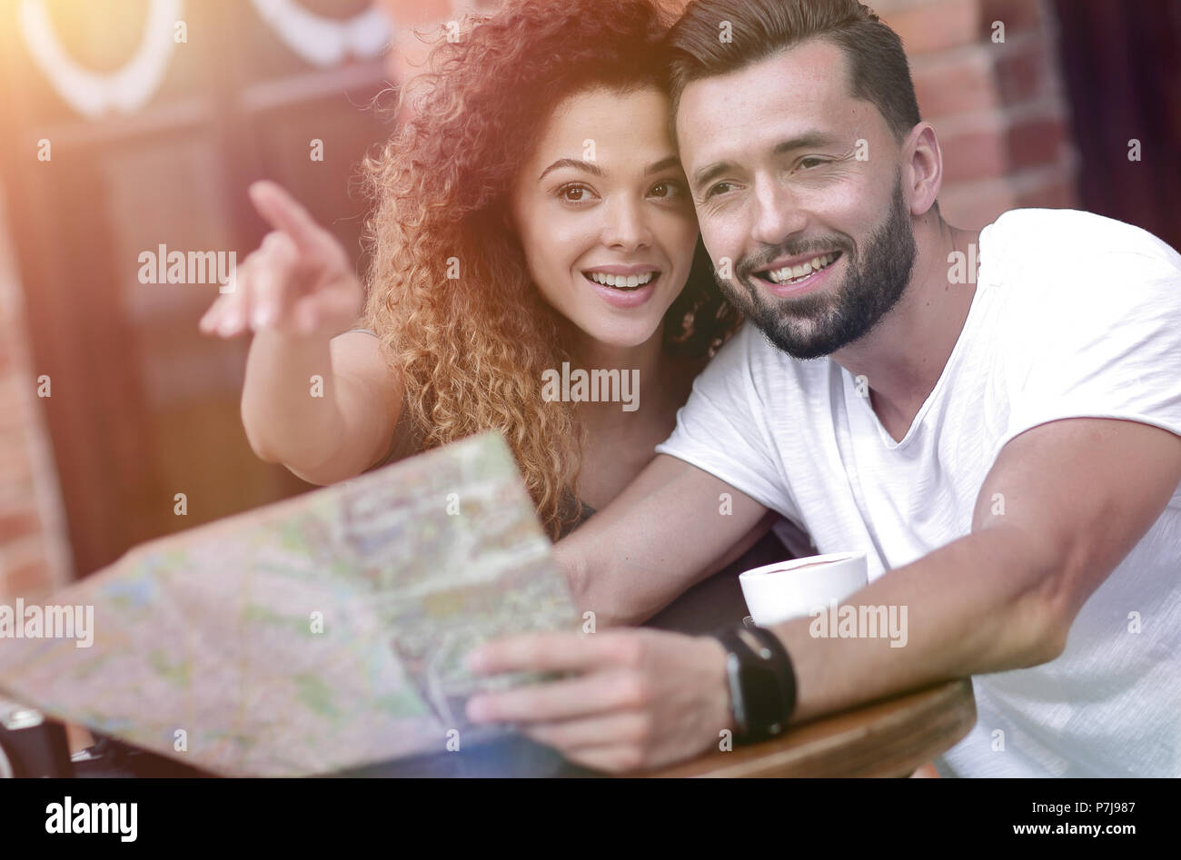 A picture of tourists looking at map in a cafe Stock Photo - Alamy