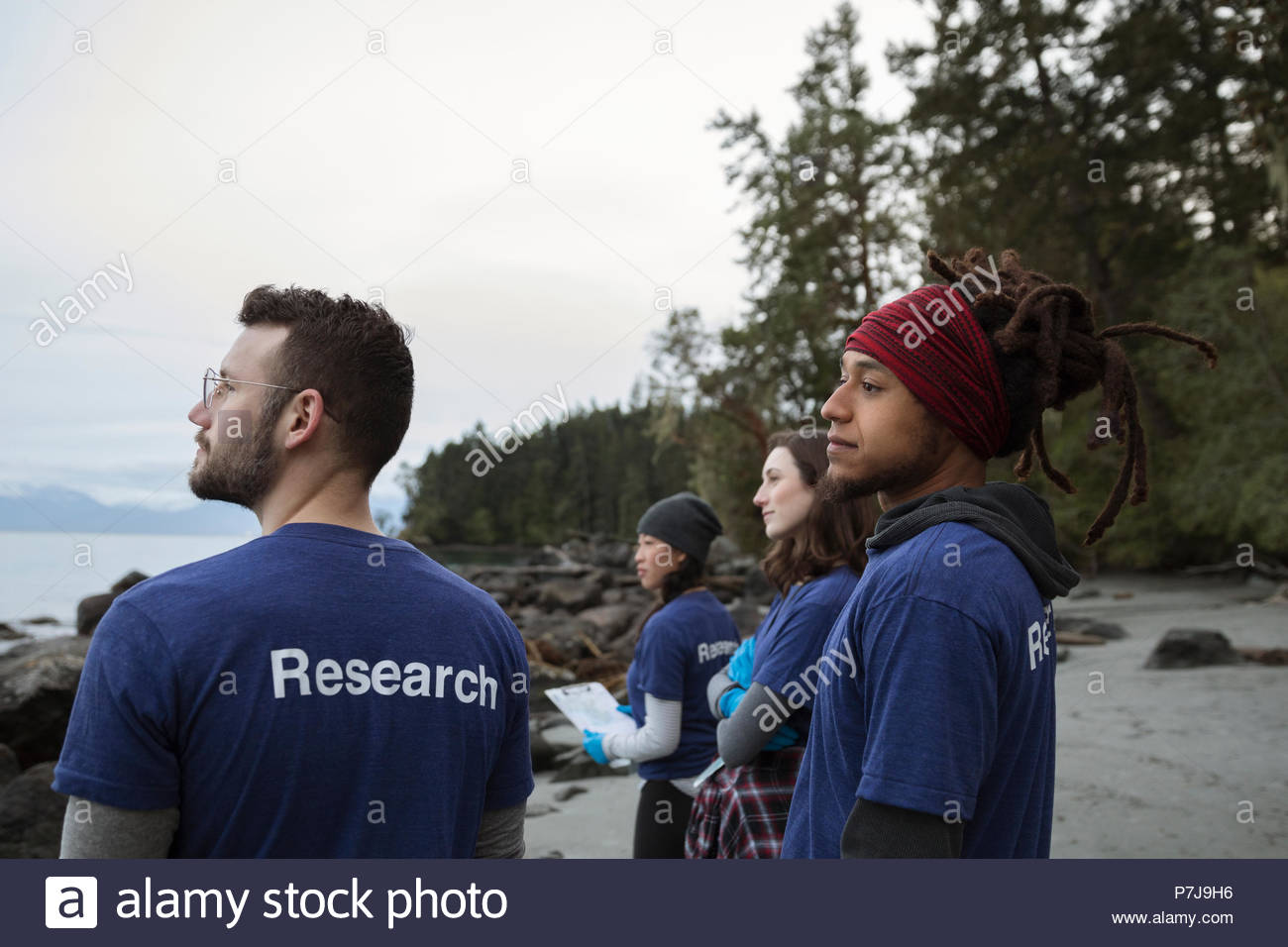 Eco-friendly scientists on rugged beach Stock Photo - Alamy