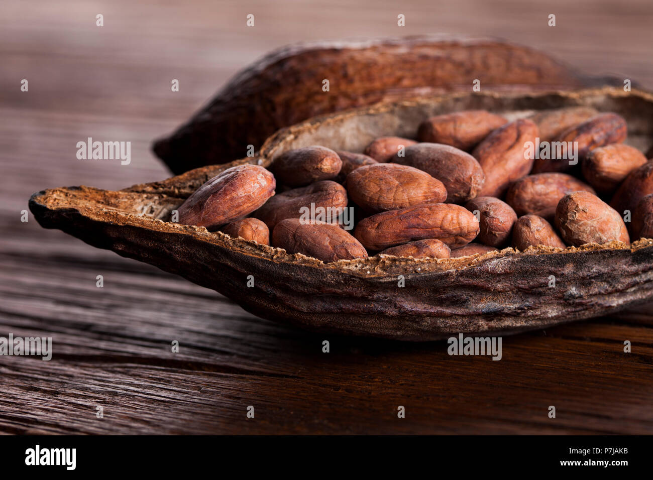 Cocoa pod on wooden table Stock Photo - Alamy