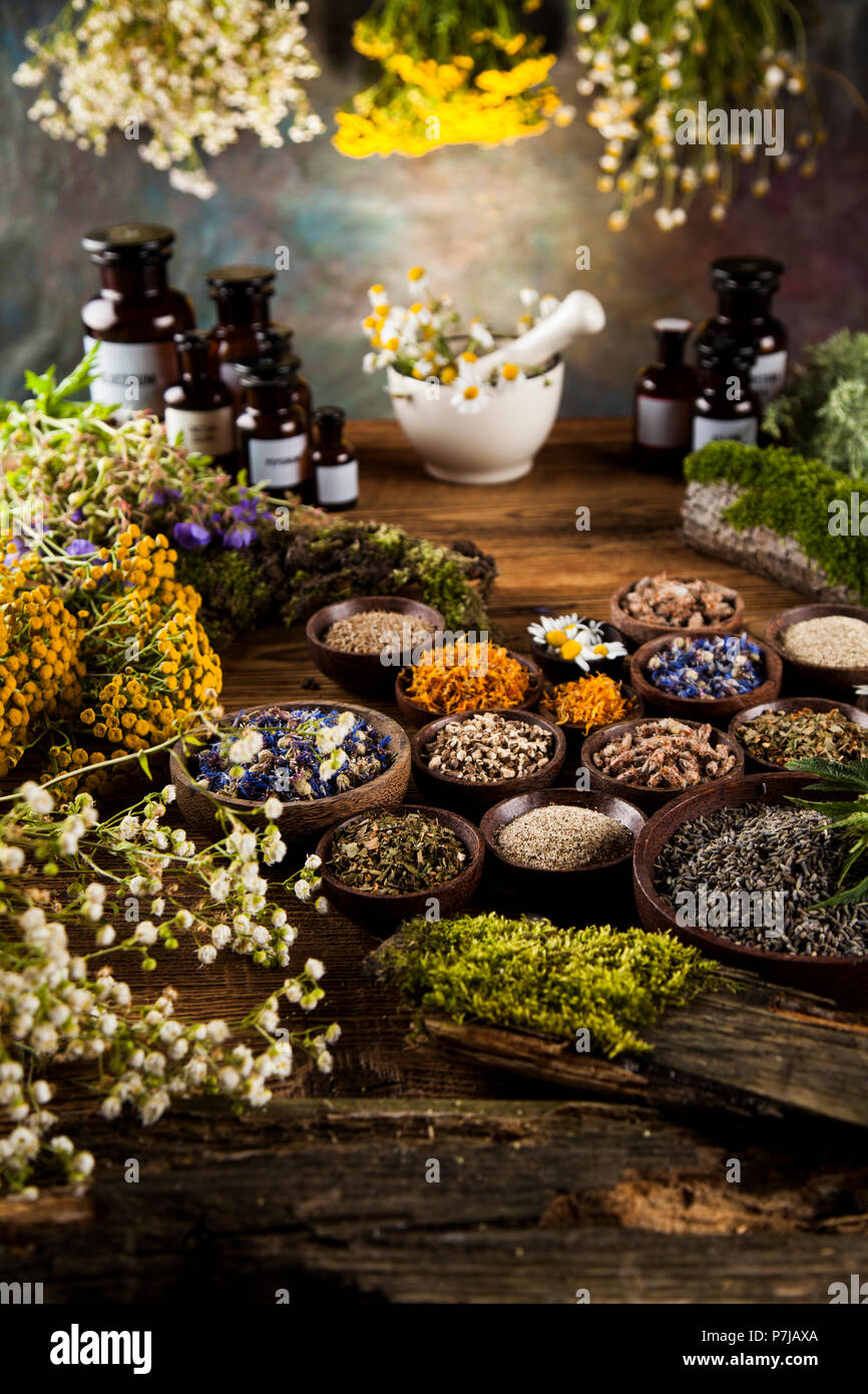 Natural remedy and mortar, healing herbs background Stock Photo - Alamy