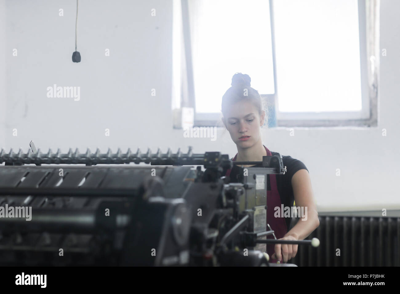 Woman operating a printing press in a factory Stock Photo - Alamy