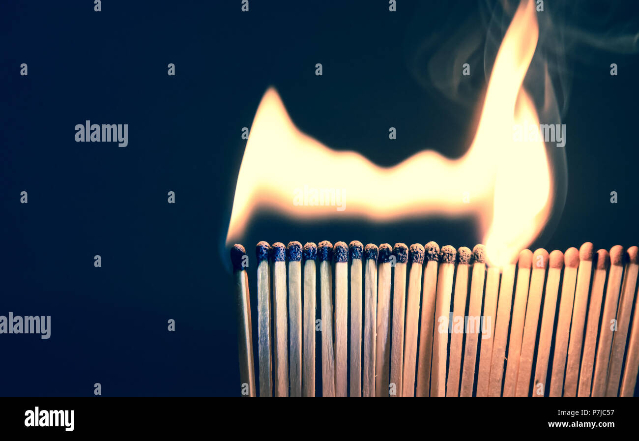 Matchsticks stacked beside each other on fire, aligned matchsticks that ...