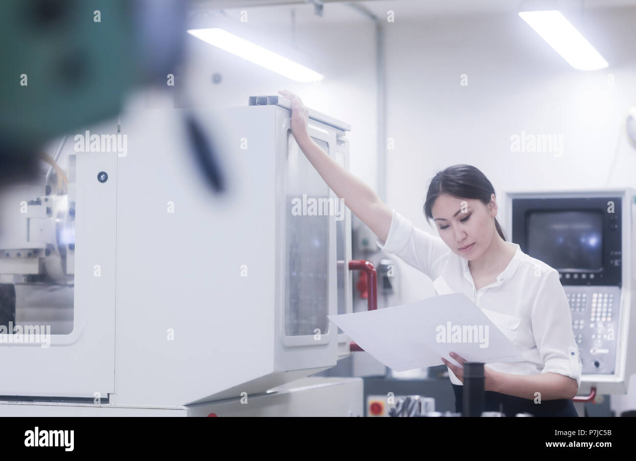 Confused Female engineer looking at a technical drawing Stock Photo - Alamy