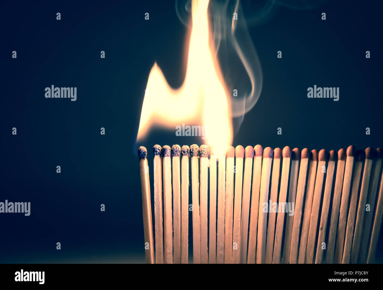 Matchsticks stacked beside each other on fire, aligned matchsticks that ...