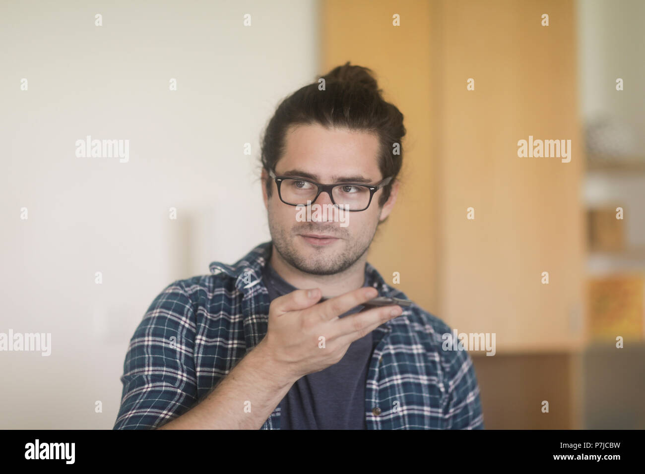 Portrait of a man talking into a mobile phone Stock Photo - Alamy