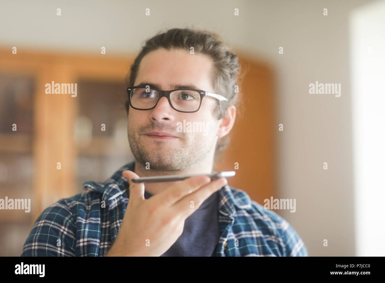 Portrait of a man talking into a mobile phone Stock Photo - Alamy