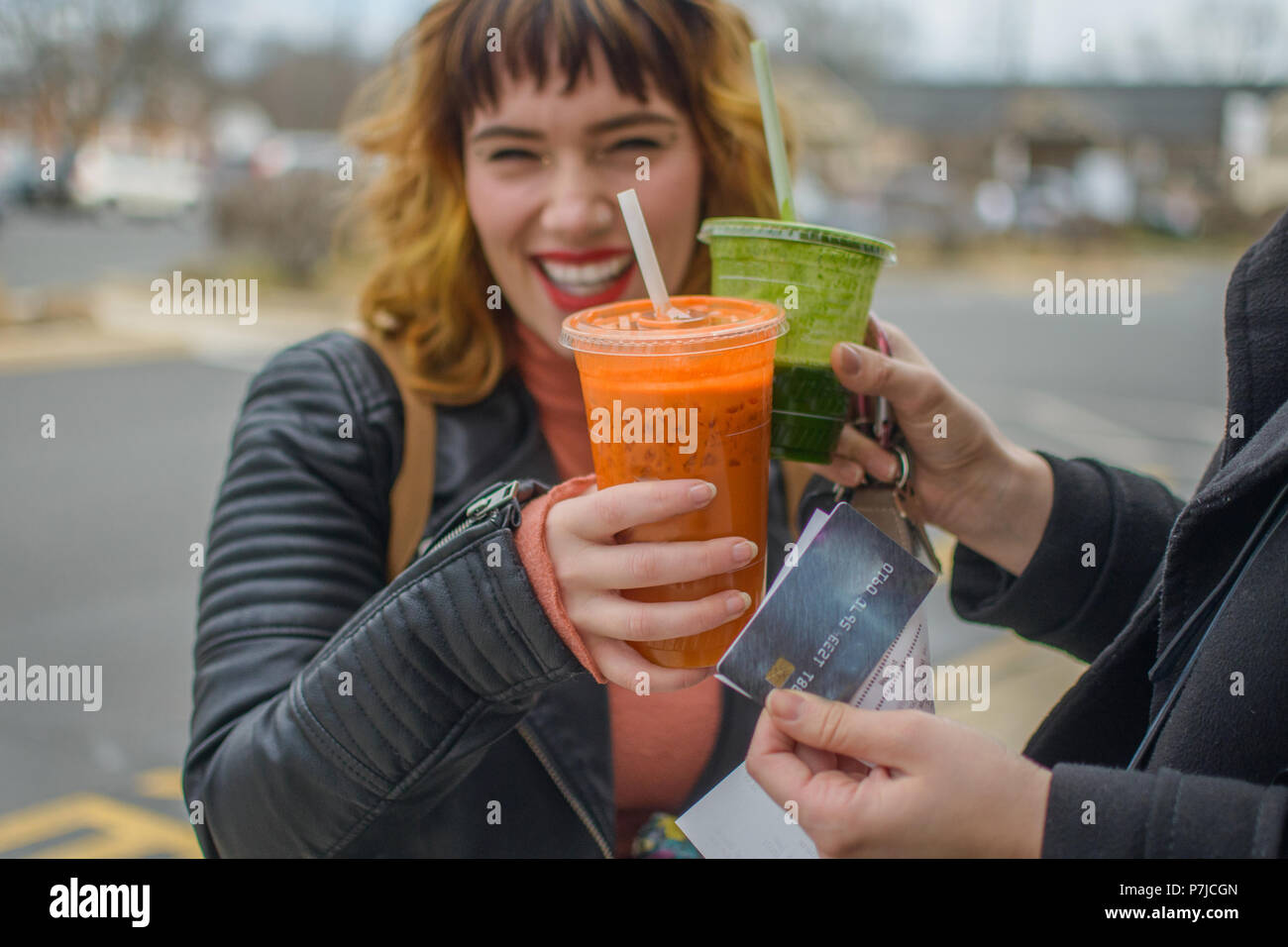 Two women making a celebratory toast with juice drinks Stock Photo - Alamy