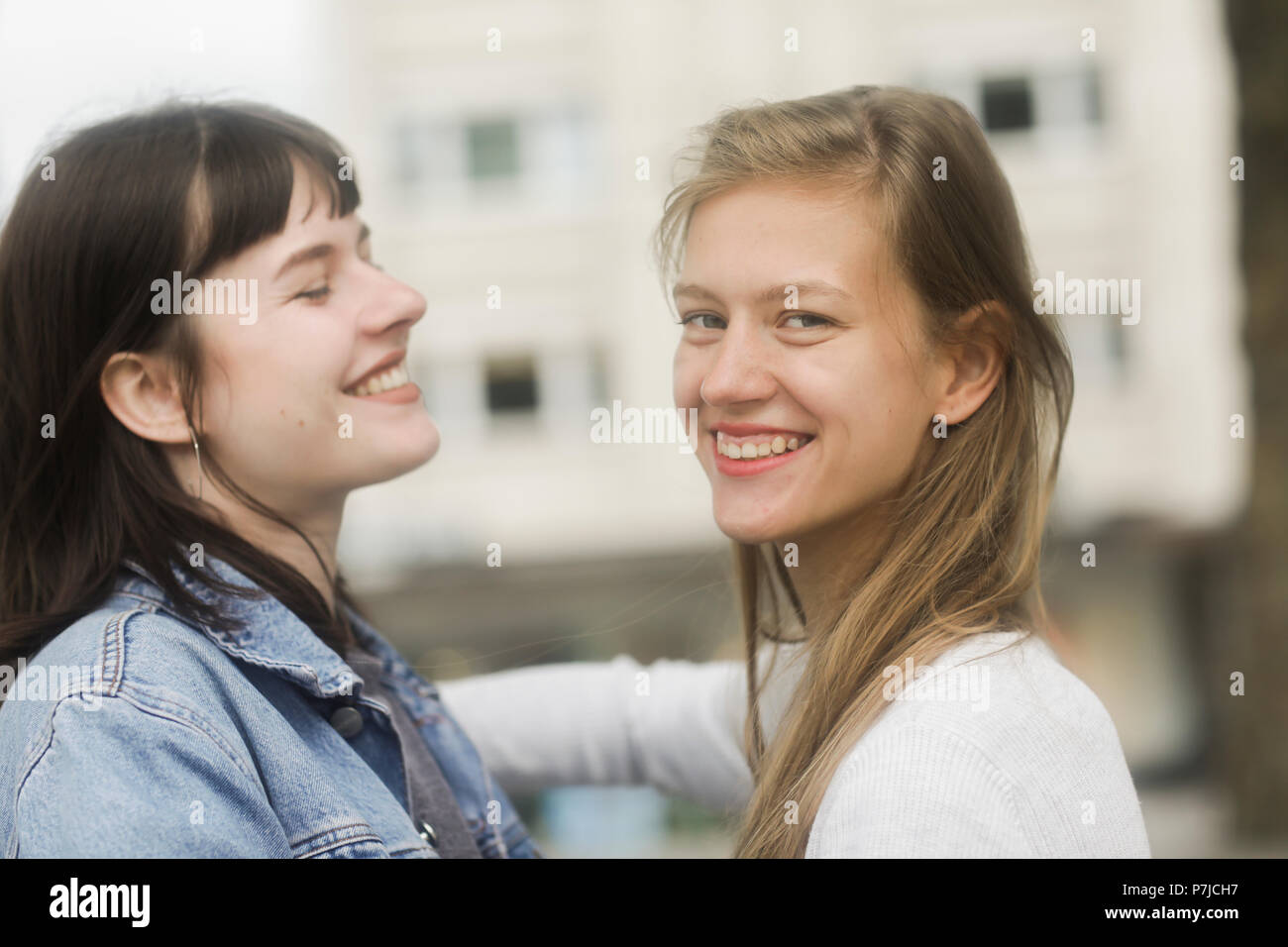 Two smiling women greeting each other Stock Photo - Alamy