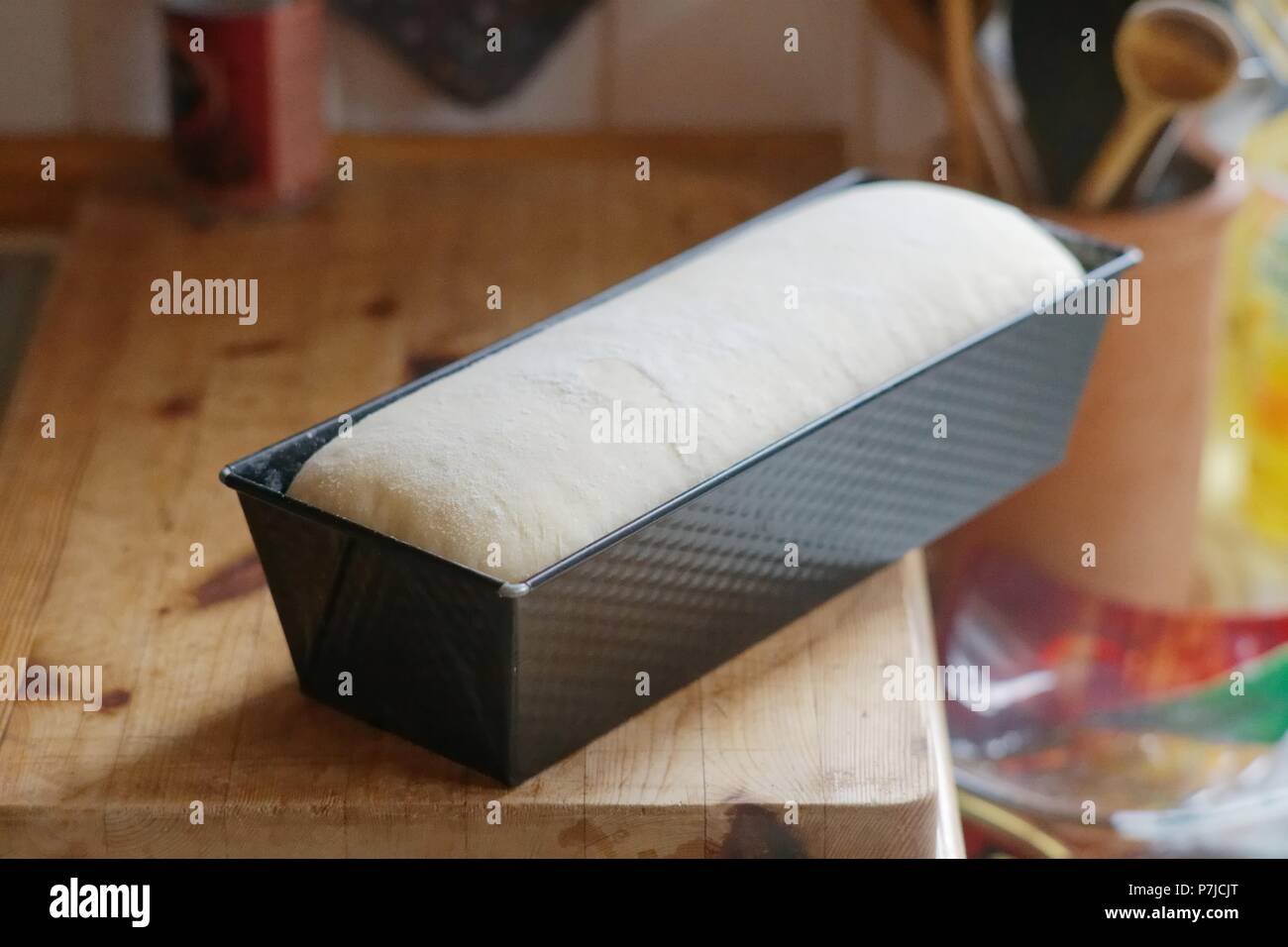 Loaf of raw bread dough in a baking tin Stock Photo - Alamy