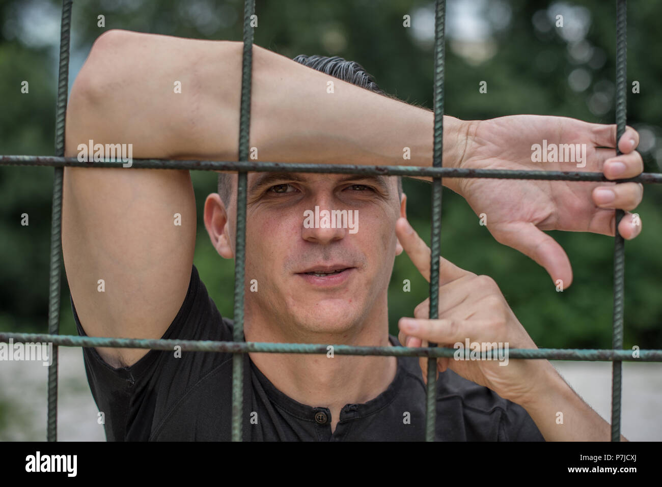 Person in front of a fence hi-res stock photography and images - Alamy