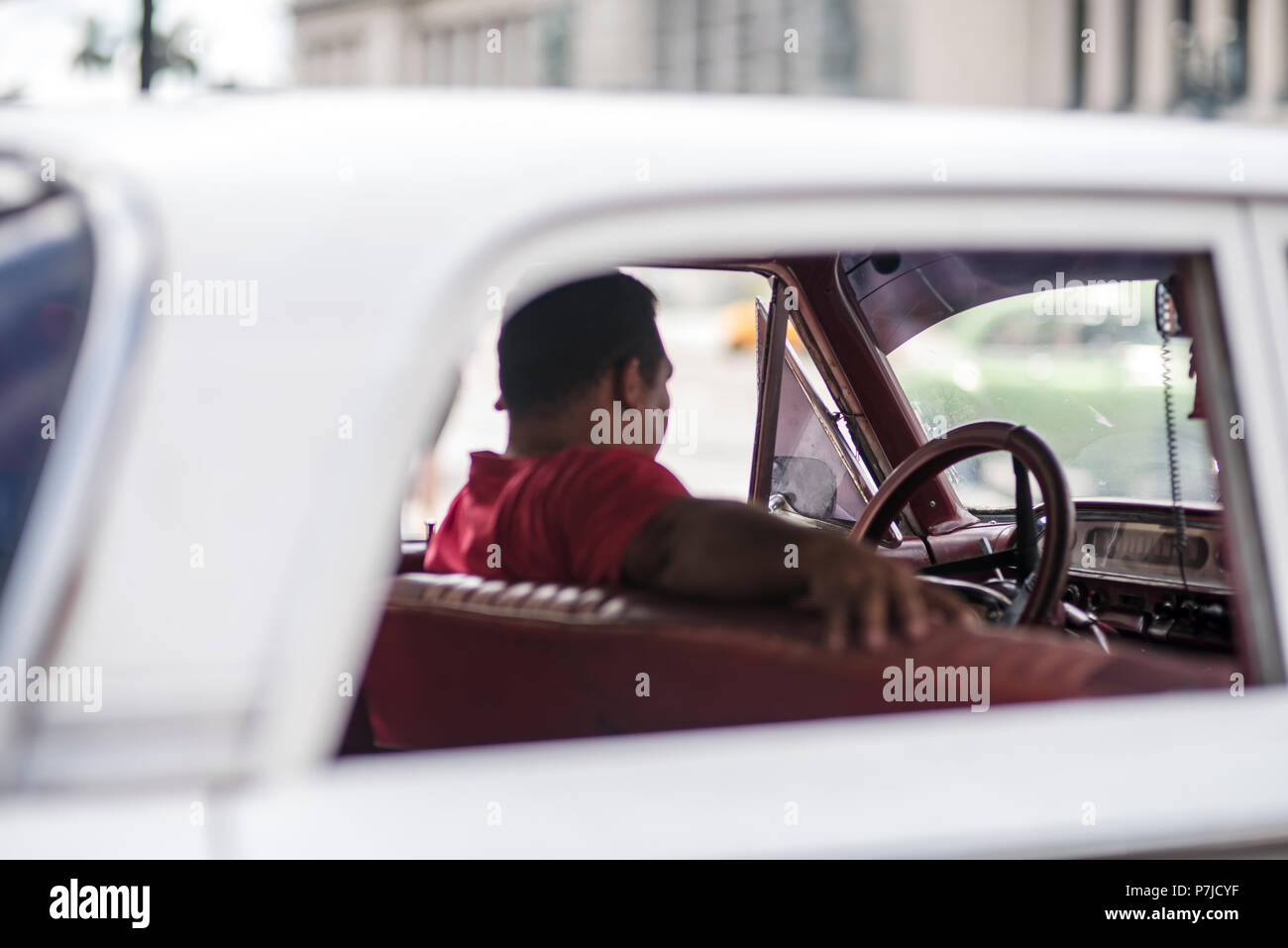 A cab driver waits for a tourist to climb into his classic car for a ...