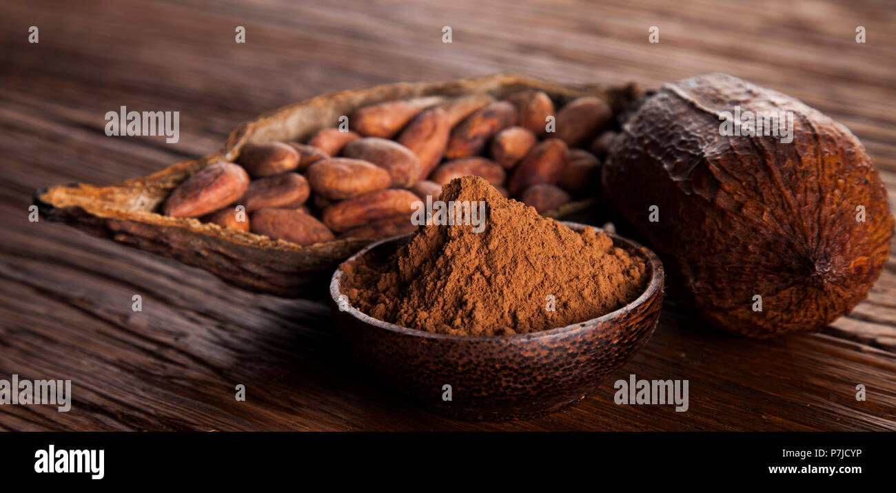 Cocoa beans in the dry cocoa pod fruit on wooden background Stock Photo ...