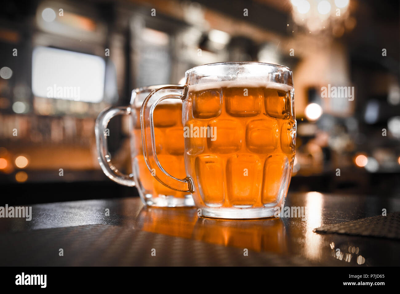 Two glass mugs of cold bar in a typical Irish pub setting Stock Photo ...
