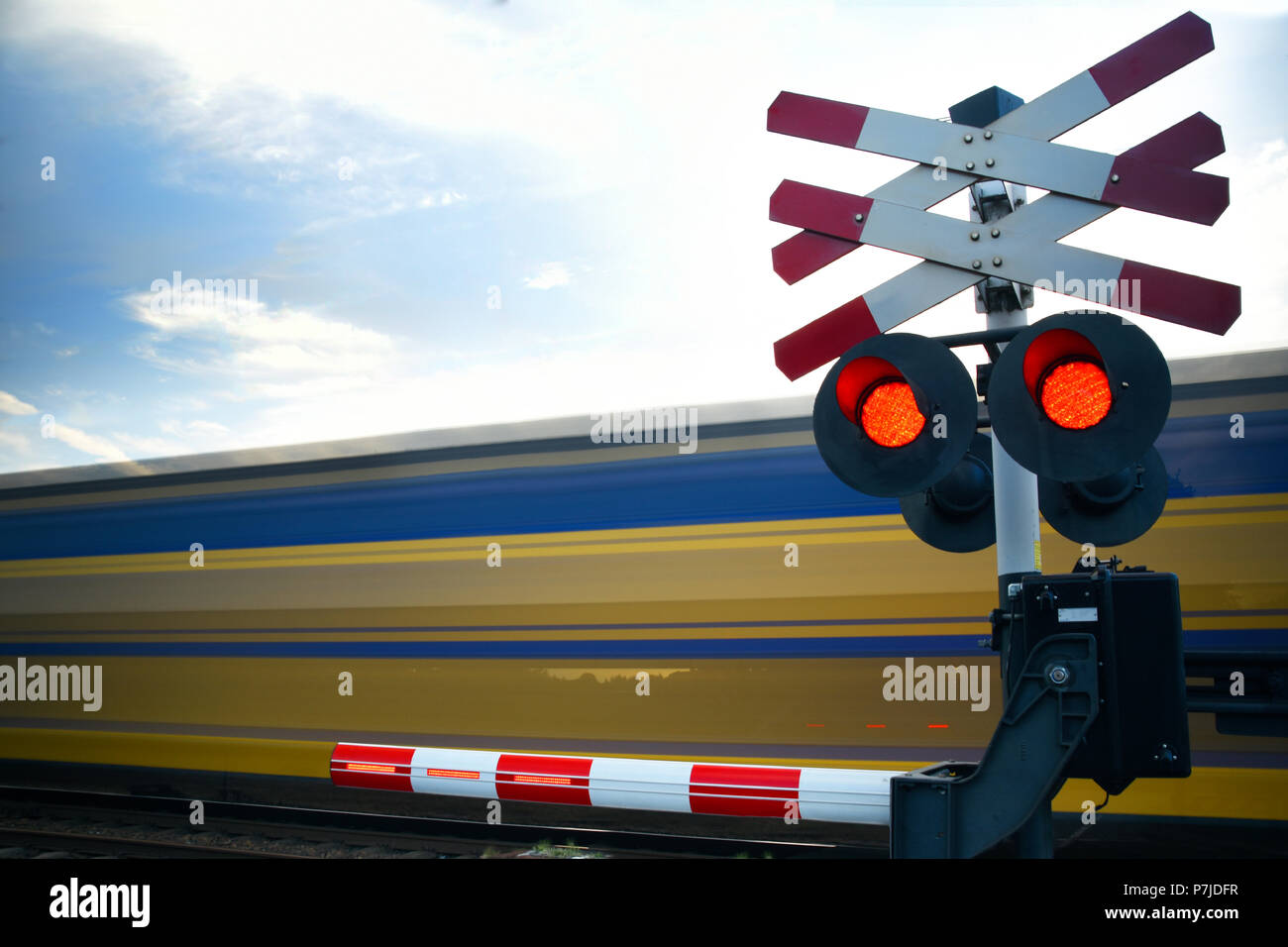 Train railroad crossing with passing high speed riding train Stock ...