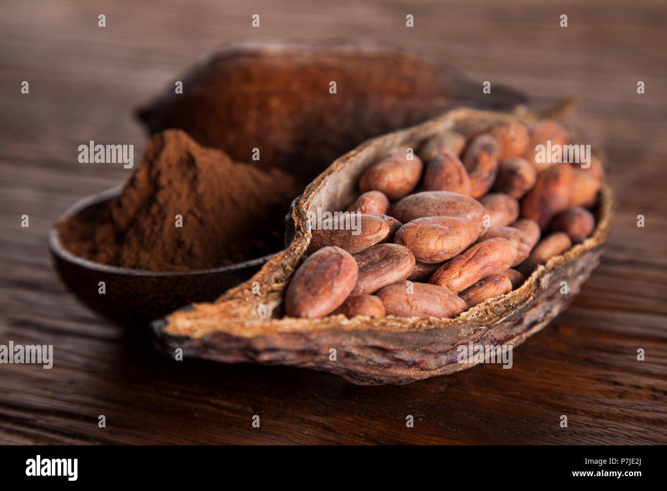 Cocoa beans in the dry cocoa pod fruit on wooden background Stock Photo ...