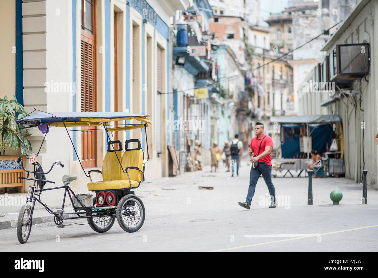 An empty bicycle cab is parked on a street in Havana, Cuba Stock Photo ...