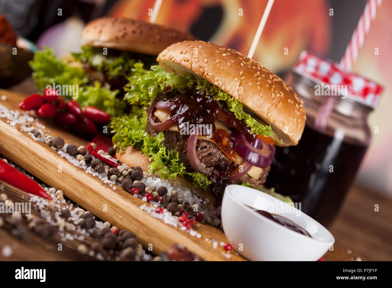 Close-up of home made burgers, wooden desk background Stock Photo - Alamy