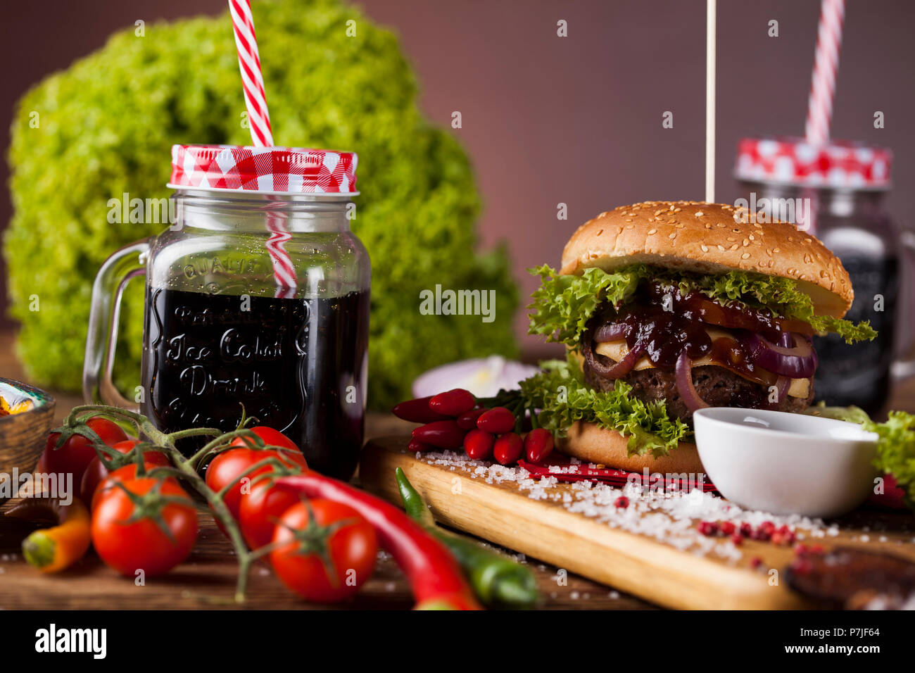Close-up of home made burgers, wooden desk background Stock Photo - Alamy