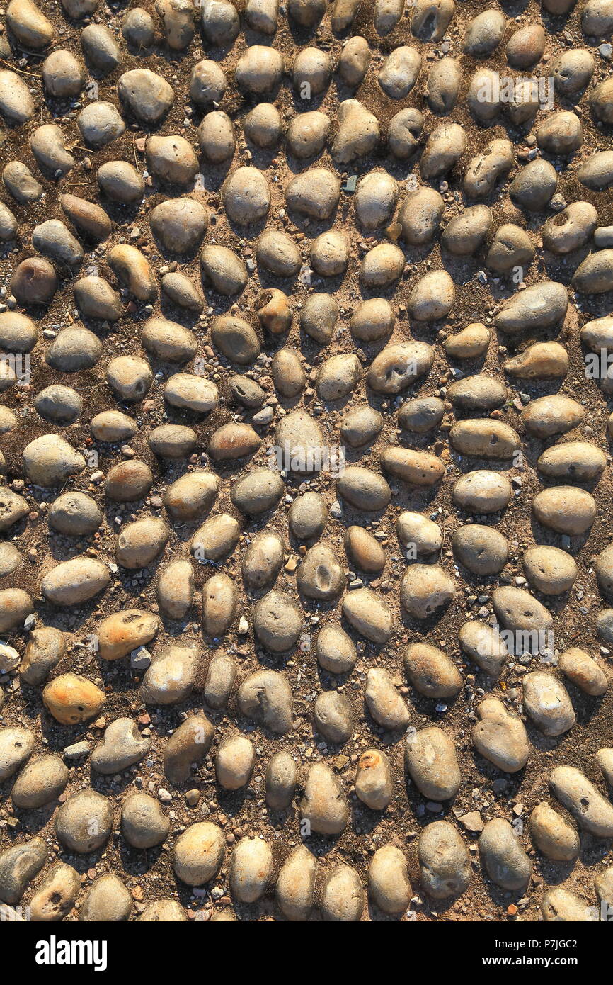Detail of circular round pebble outdoor flooring Stock Photo - Alamy