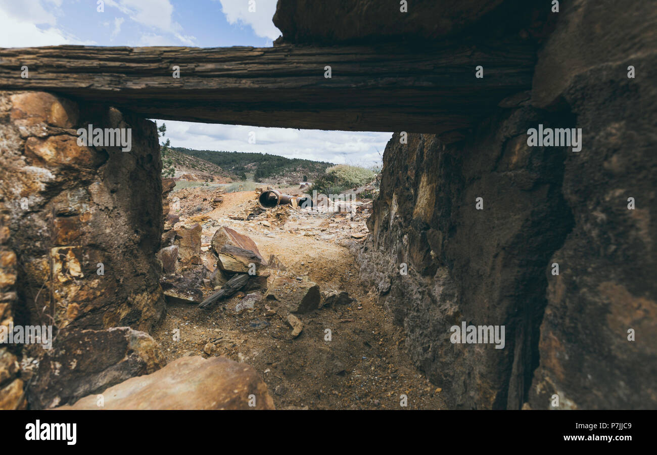 broken stone walls and rotten wooden beam, with water pipes abandoned ...