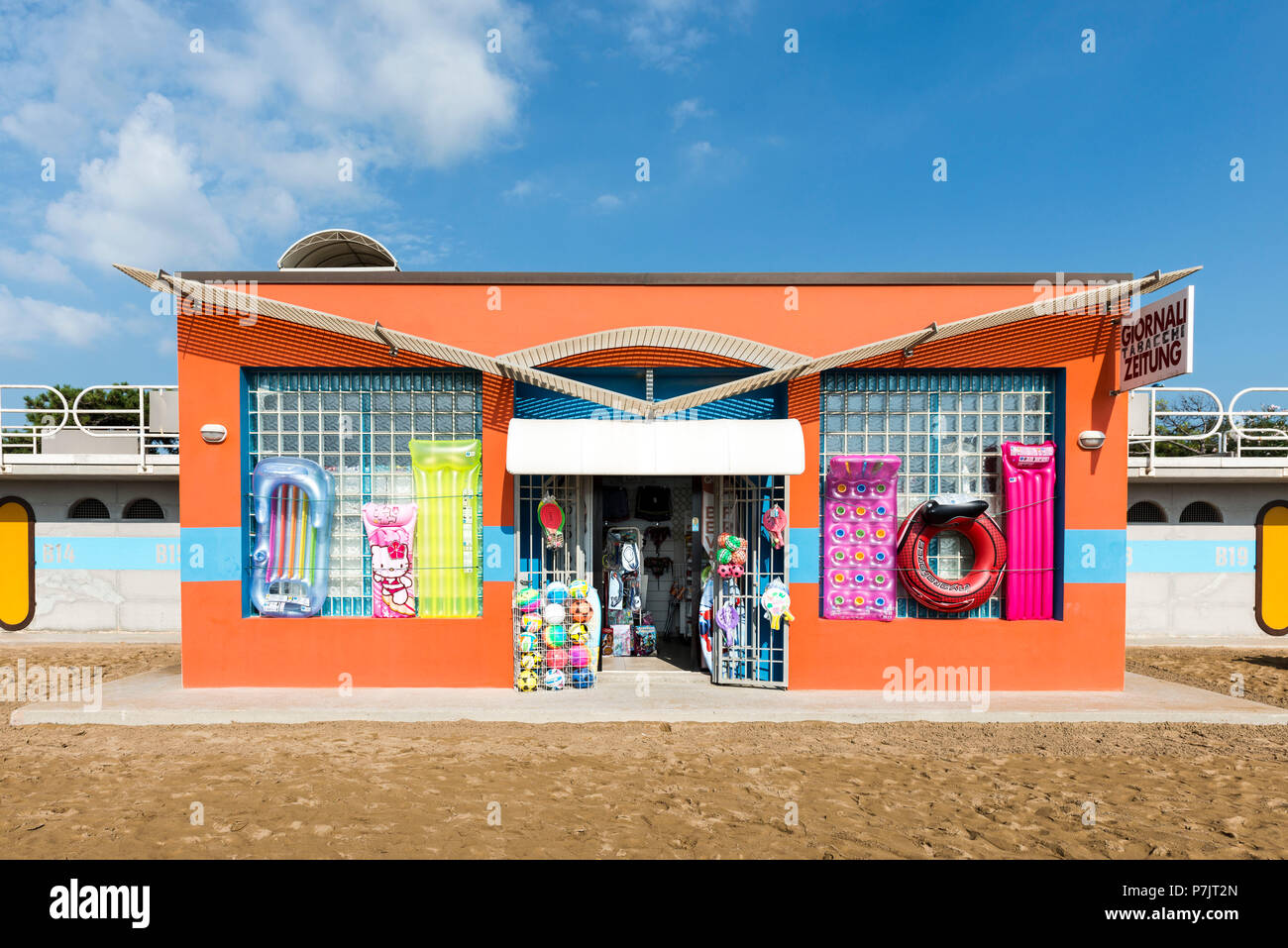Small red beach shop with displayed products, architecture on the beach ...