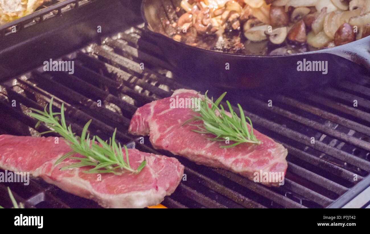 Step by step. Grilling New York strip steak on outdoor gas grill Stock ...