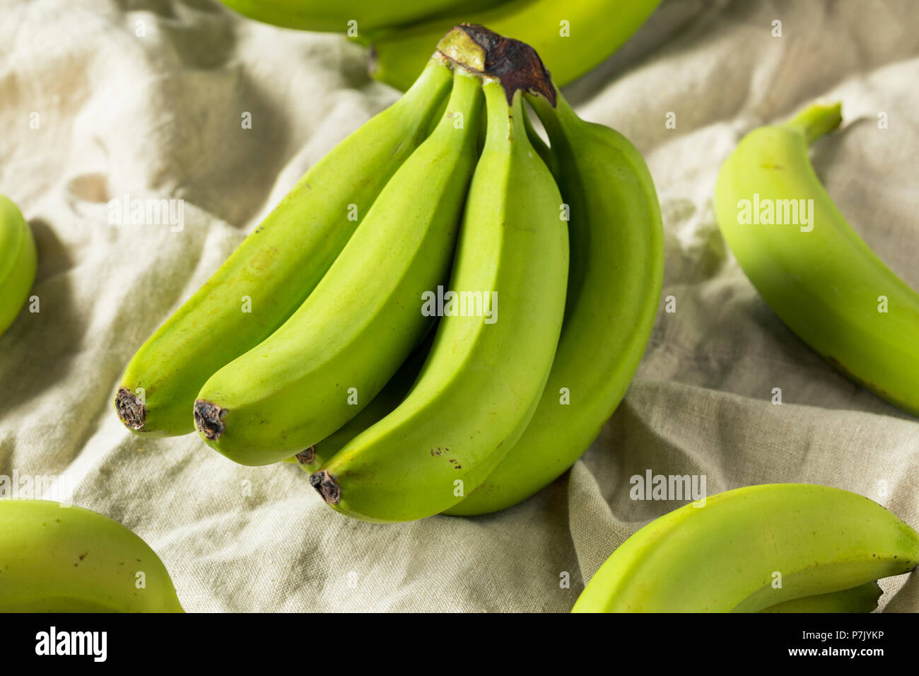 Organic Raw Green Unripe Bananas in a Bunch Stock Photo - Alamy