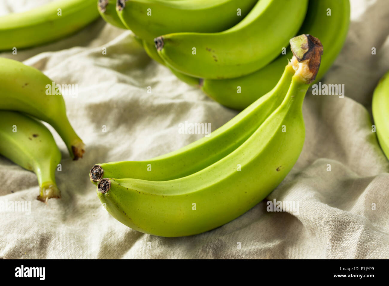 Organic Raw Green Unripe Bananas in a Bunch Stock Photo - Alamy