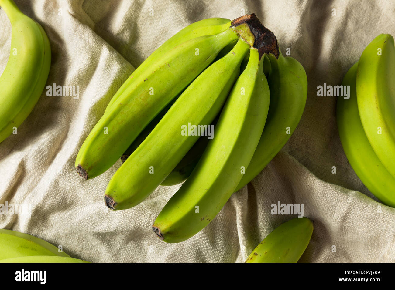 Organic Raw Green Unripe Bananas in a Bunch Stock Photo - Alamy