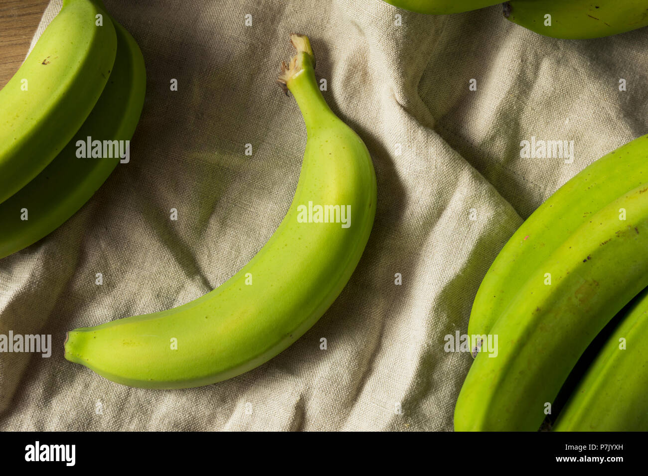 Organic Raw Green Unripe Bananas in a Bunch Stock Photo - Alamy