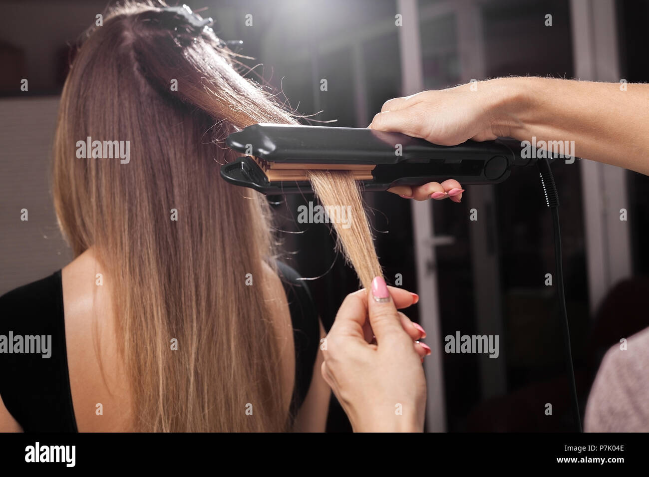 hairdresser making a gauffer hairstyle of a model Stock Photo - Alamy