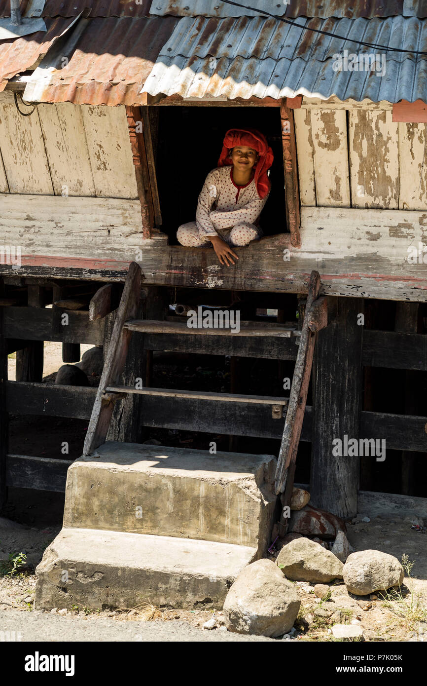 Girl at the entrance of a traditional Batak house Stock Photo - Alamy